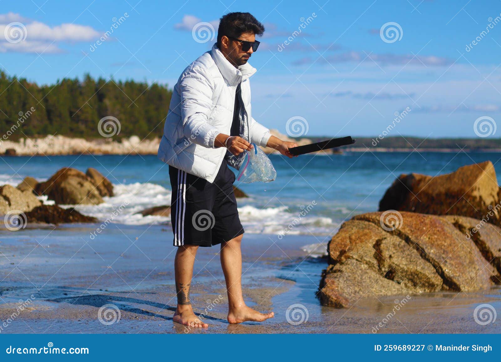 Man Picking Up Litter on Beach. Stock Image - Image of winter, sign ...