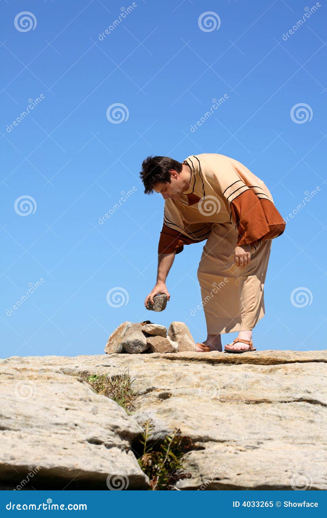 Man picking up rock - sin stock image. Image of human - 4033265