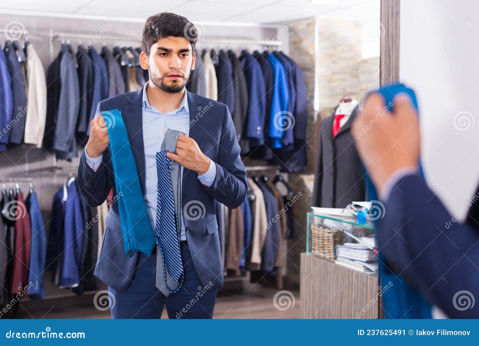 Man is Picking Up Tie for Jacket in Front of the Mirror Stock Image ...