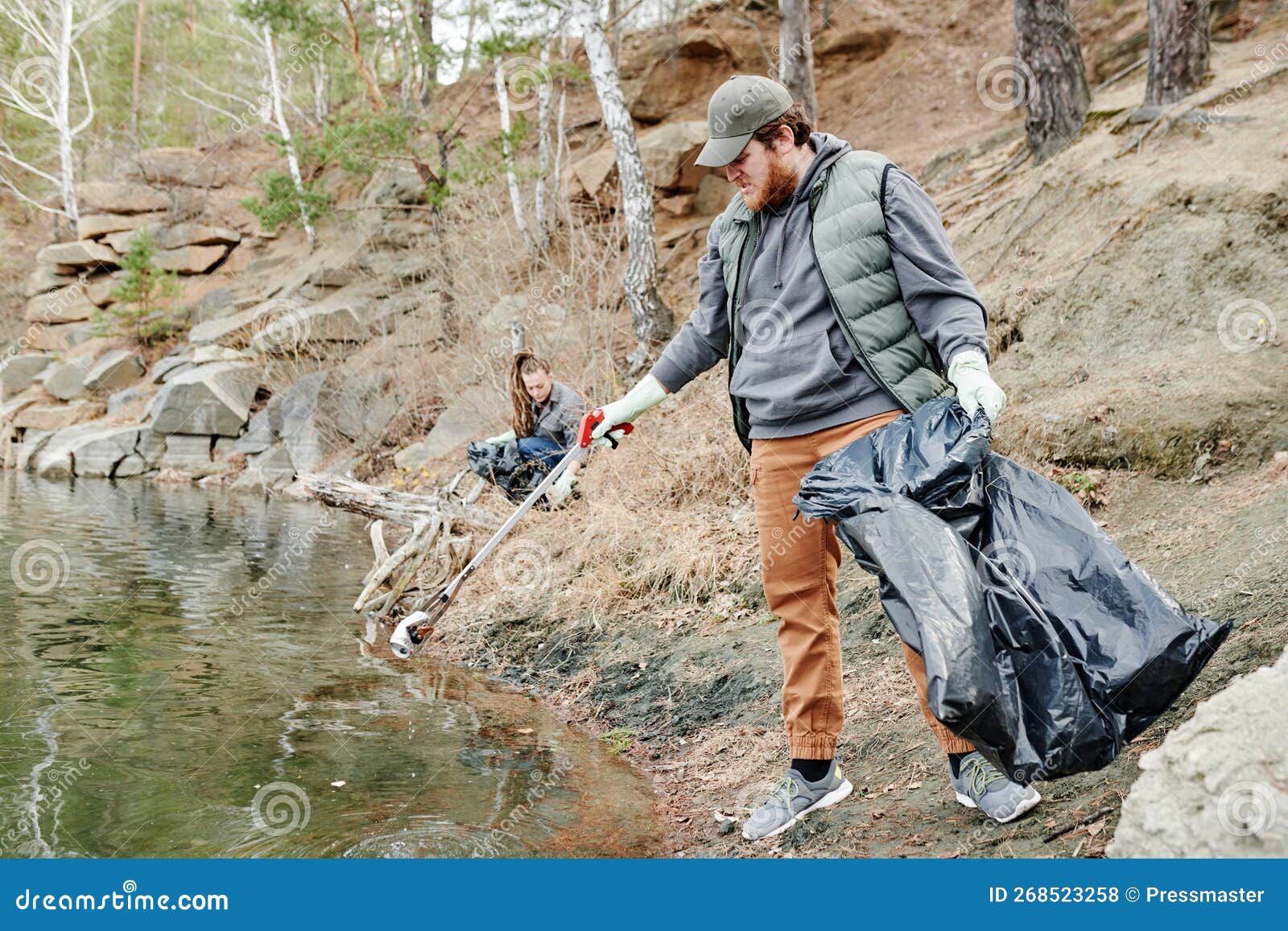 Man Picking up Trash stock photo. Image of care, trash - 268523258