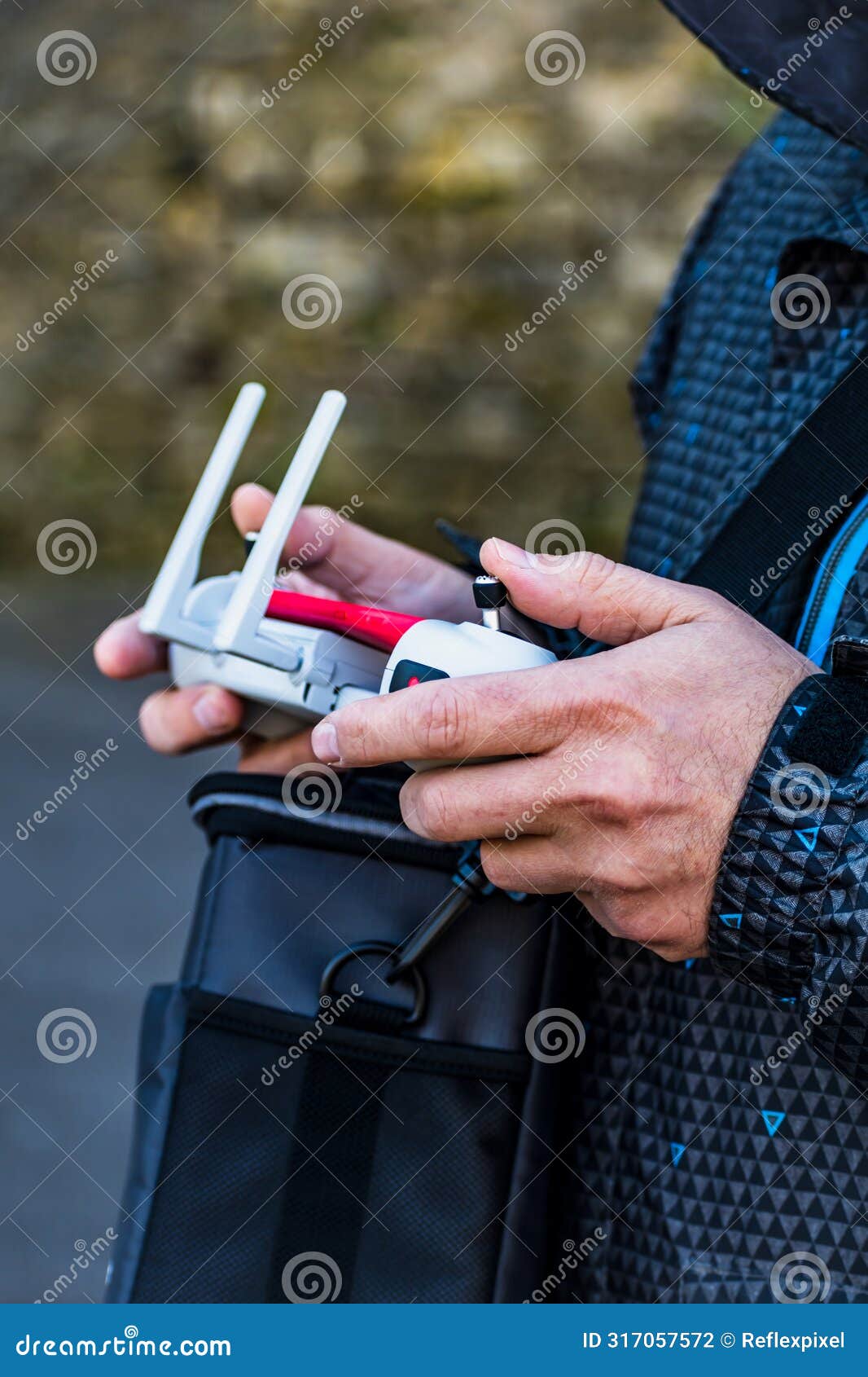 Man Piloting a Drone Using a Controller Equipped with a Joystick and a ...