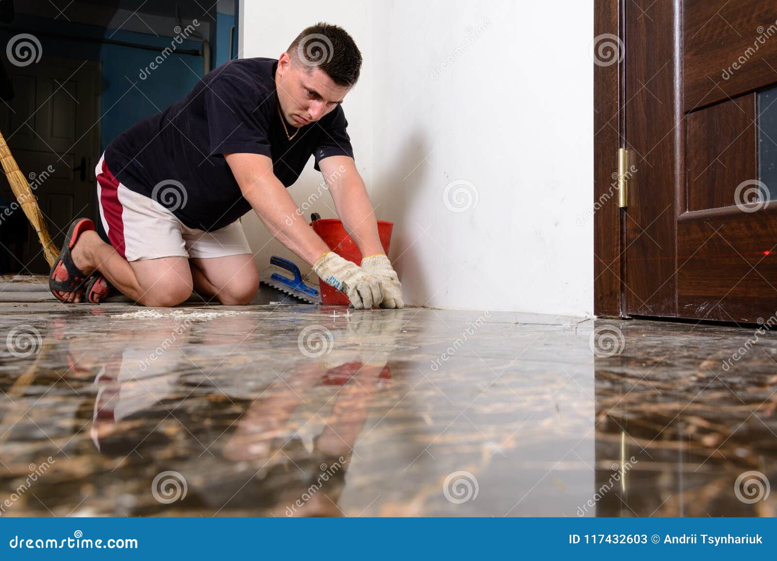 Man Placing Ceramic Floor Tile in Position Over Adhesive Stock Image ...