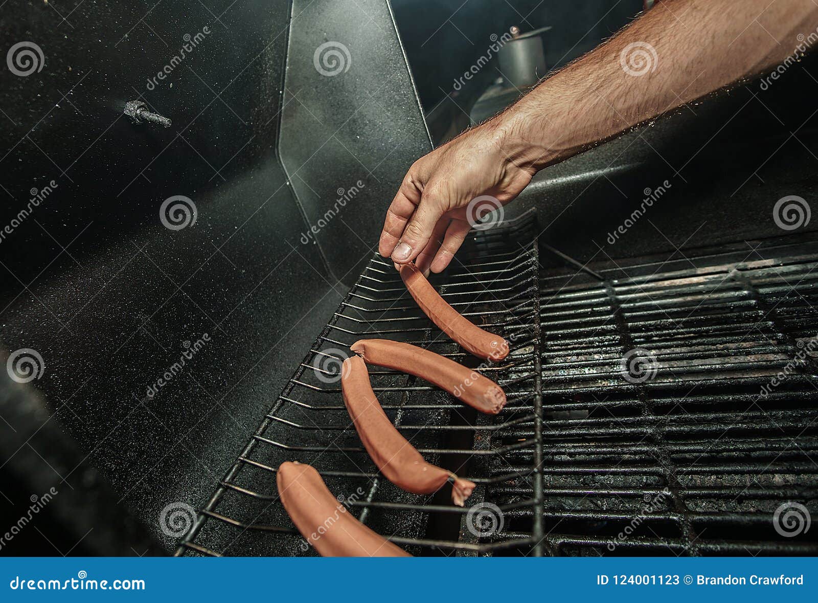 A Man Placing Hot Dogs on a Grill Stock Image - Image of grill, dogs ...