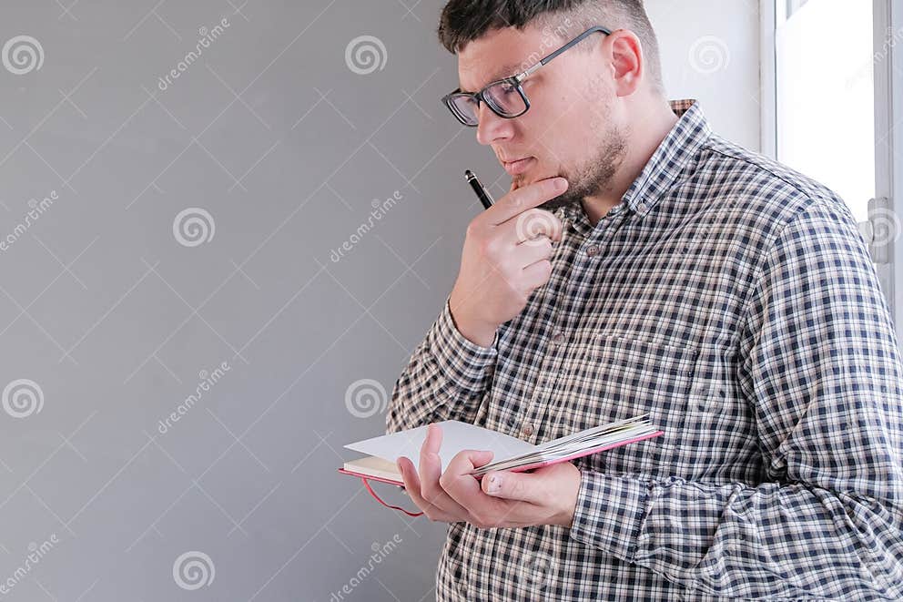 Man in Plaid Shirt Sitting at Windowsill , Thinking and Writing in a ...