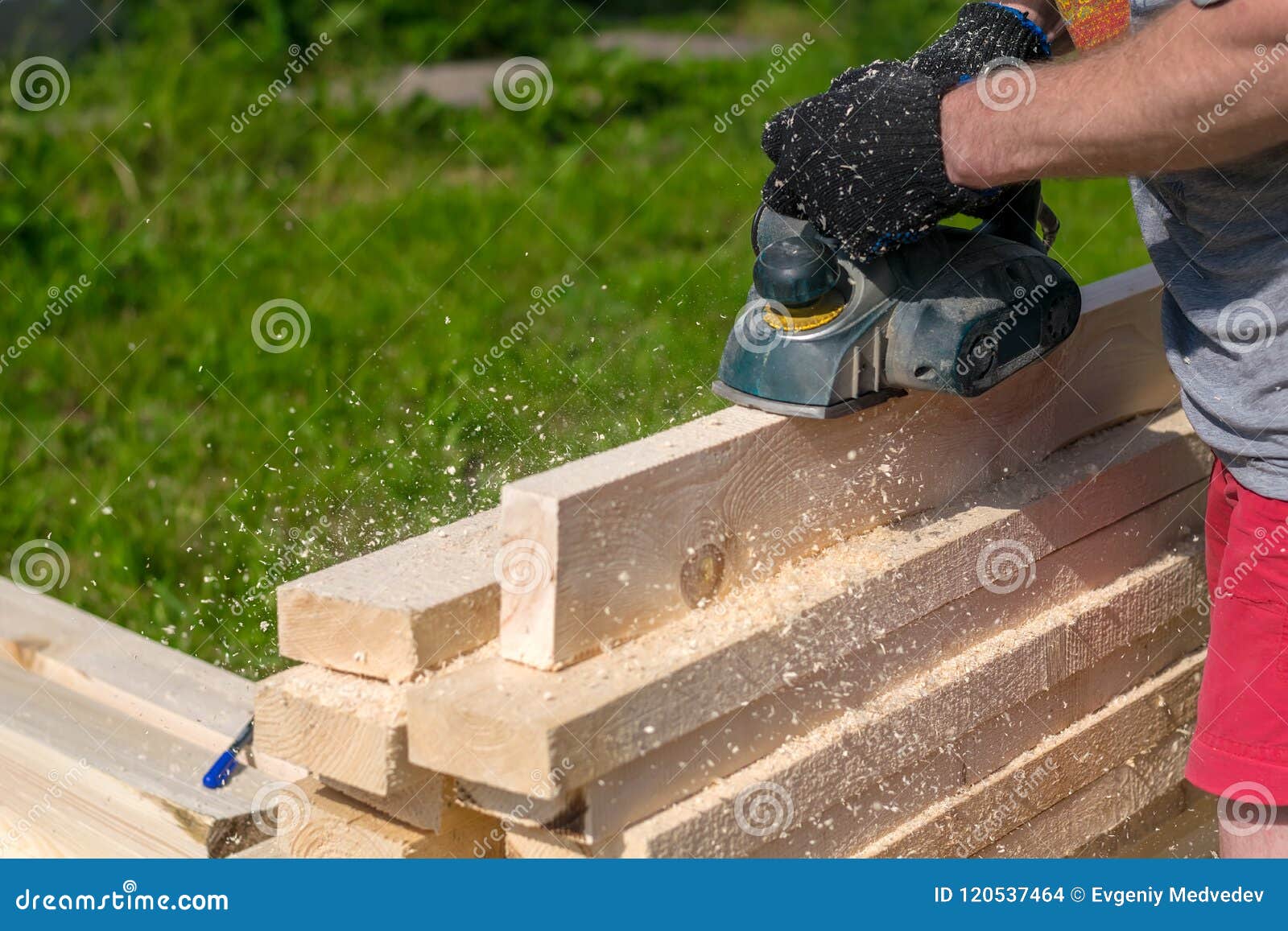 Man Planing Boards with Electric Tools, Chips Flying in All Directions ...