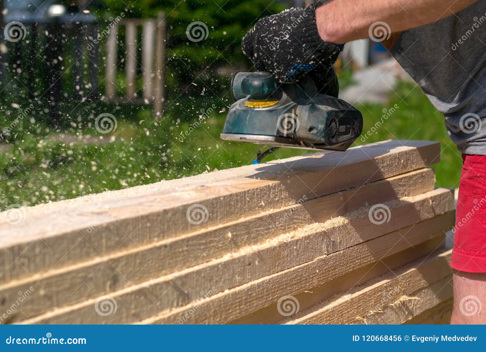 Man Planing Boards with Electric Tools, Chips Flying in All Directions ...