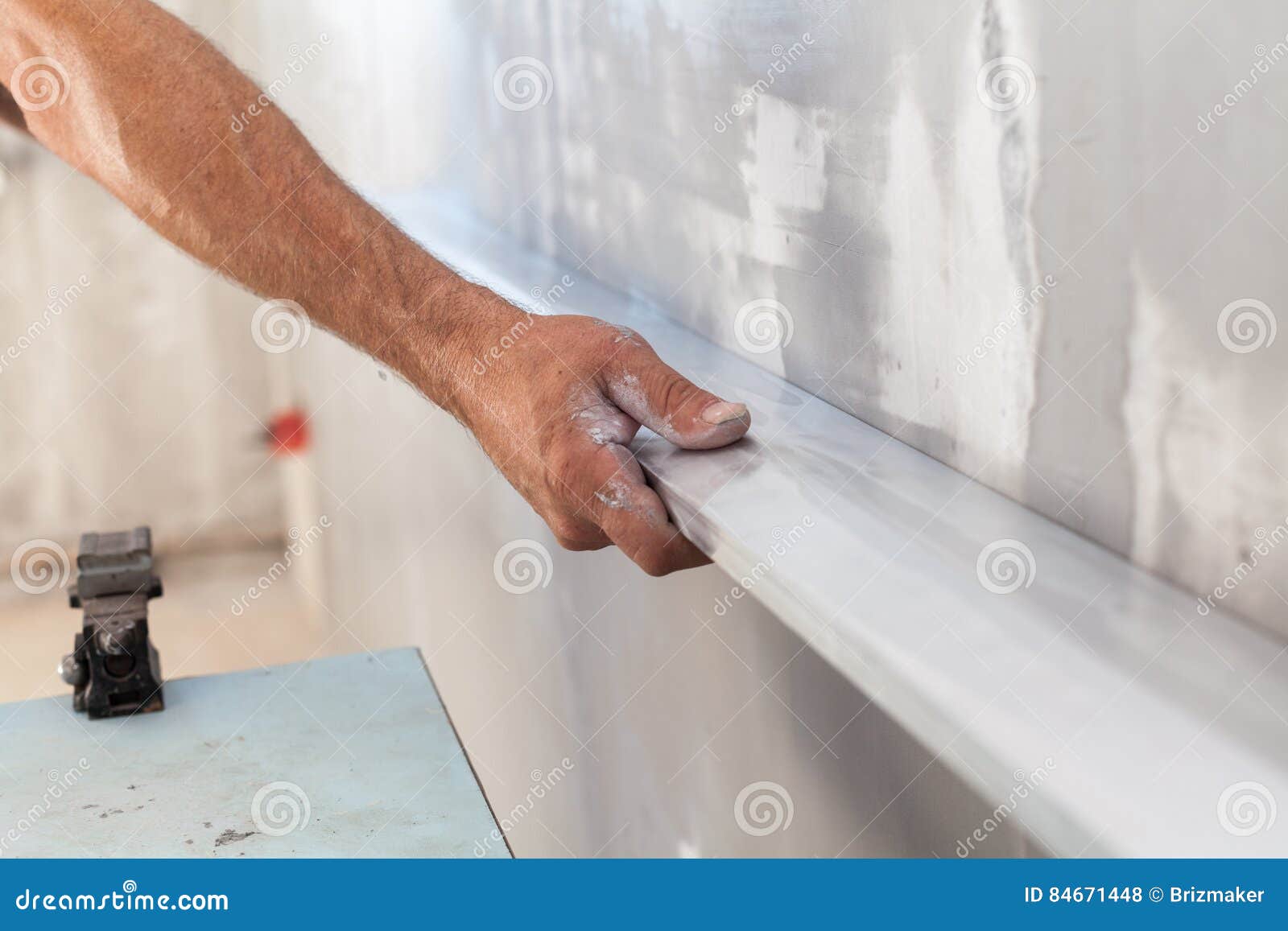 Man Plastering A Wall Using Floating Rule To Check The Flatness Stock ...