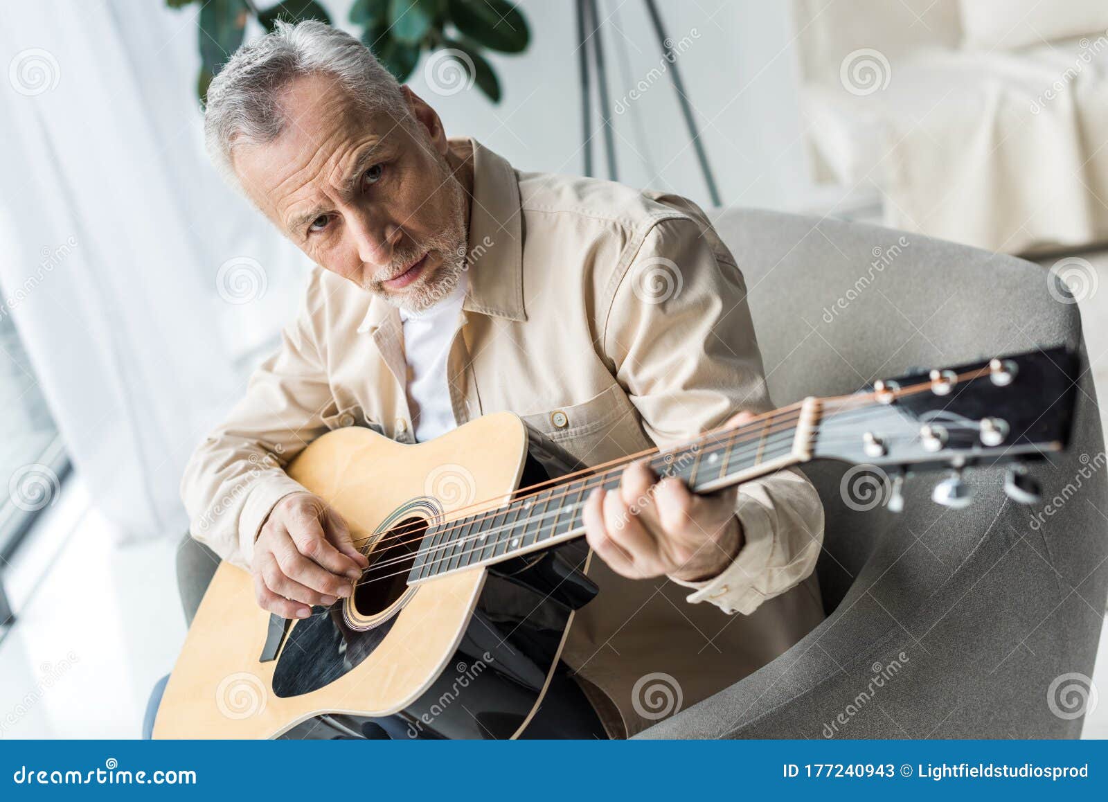 Man Playing Acoustic Guitar and Looking at Camera Stock Image - Image ...