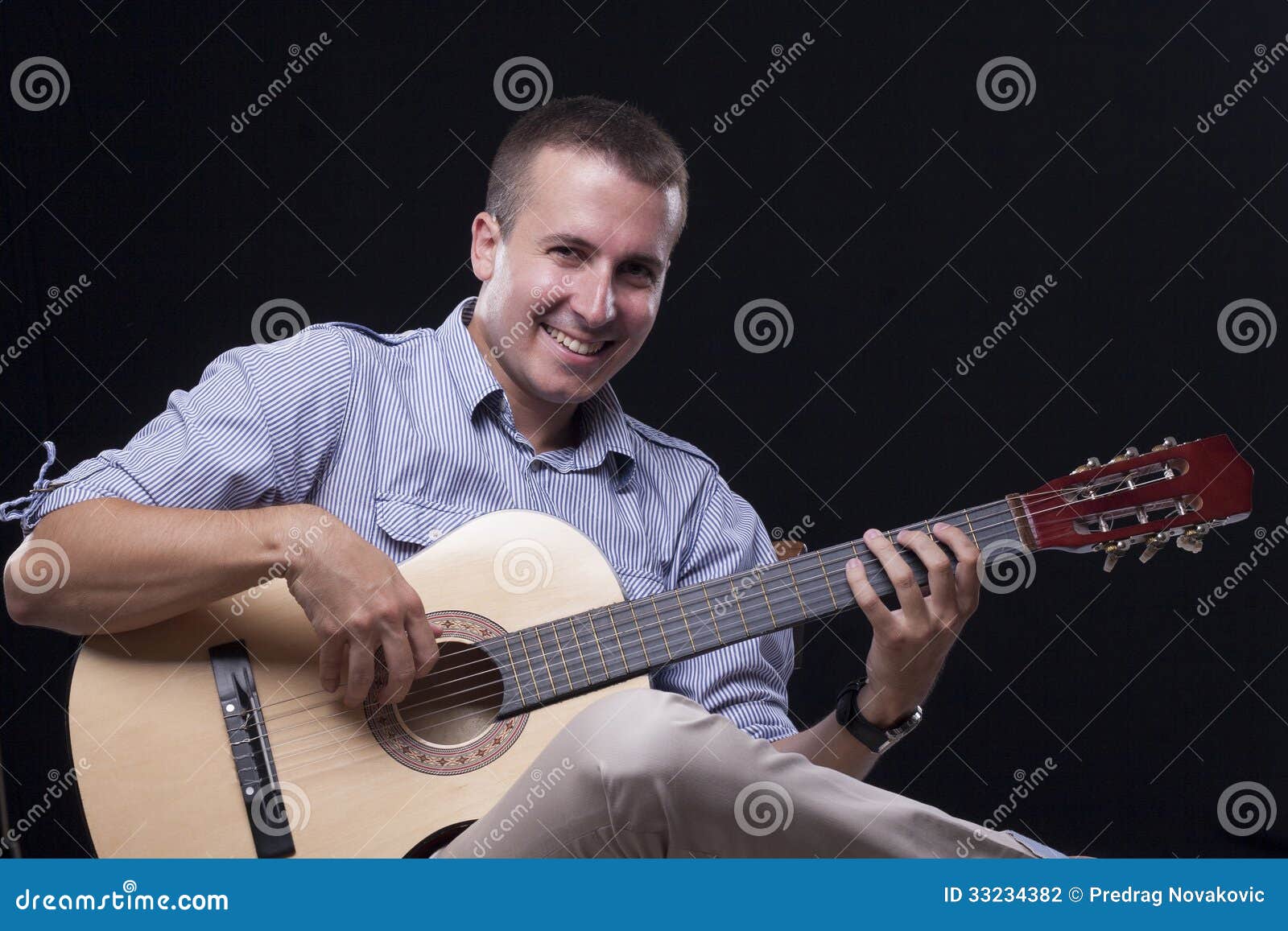Man Playing Acoustic Guitar Stock Photo - Image of chair, adults: 33234382