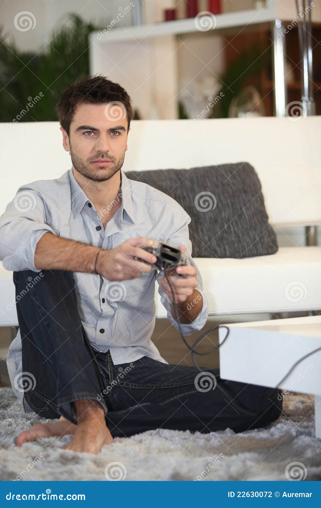 Man playing on console stock photo. Image of furniture - 22630072