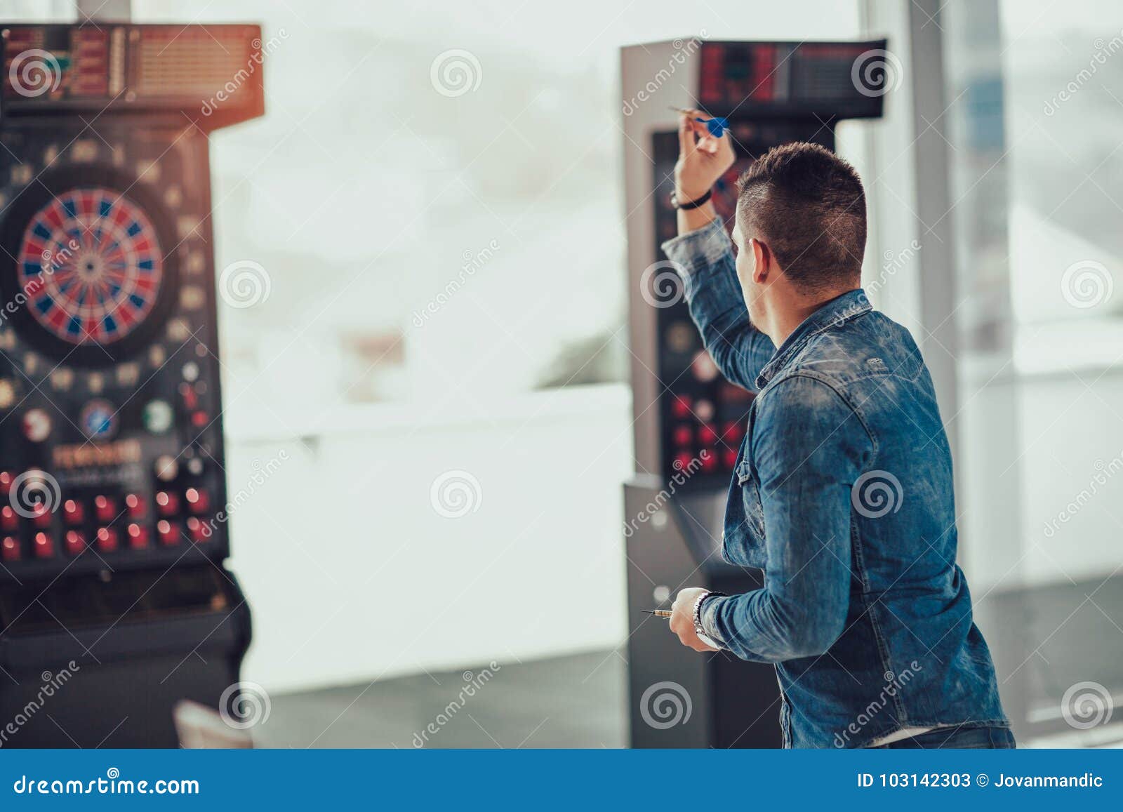Man Playing a Game Shooting Darts Stock Image - Image of indoors, game ...