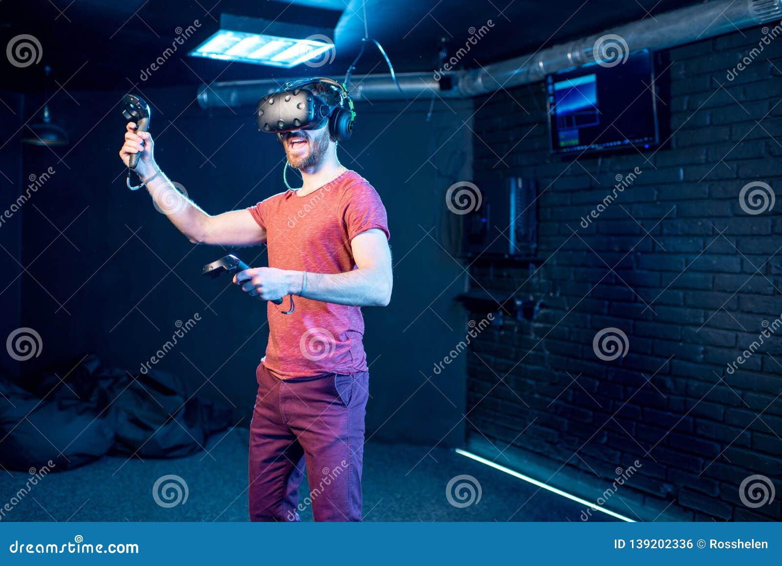 Man Playing Game with Virtual Reality Headset in the Club Stock Photo ... Man Playing Game with Virtual Reality Headset in the Club Stock Photo ...