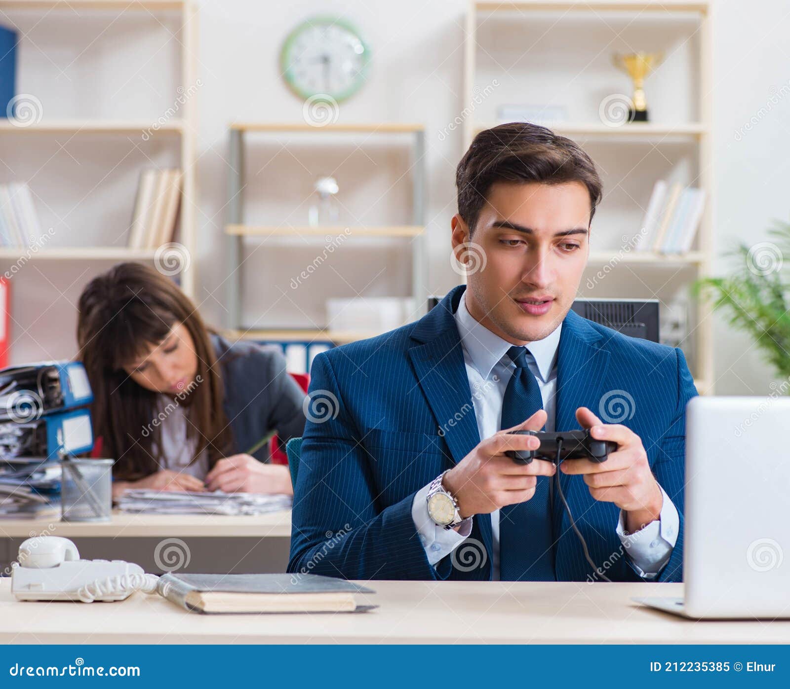 Man Playing Games in Office while Colleague is Busy Stock Image - Image ...