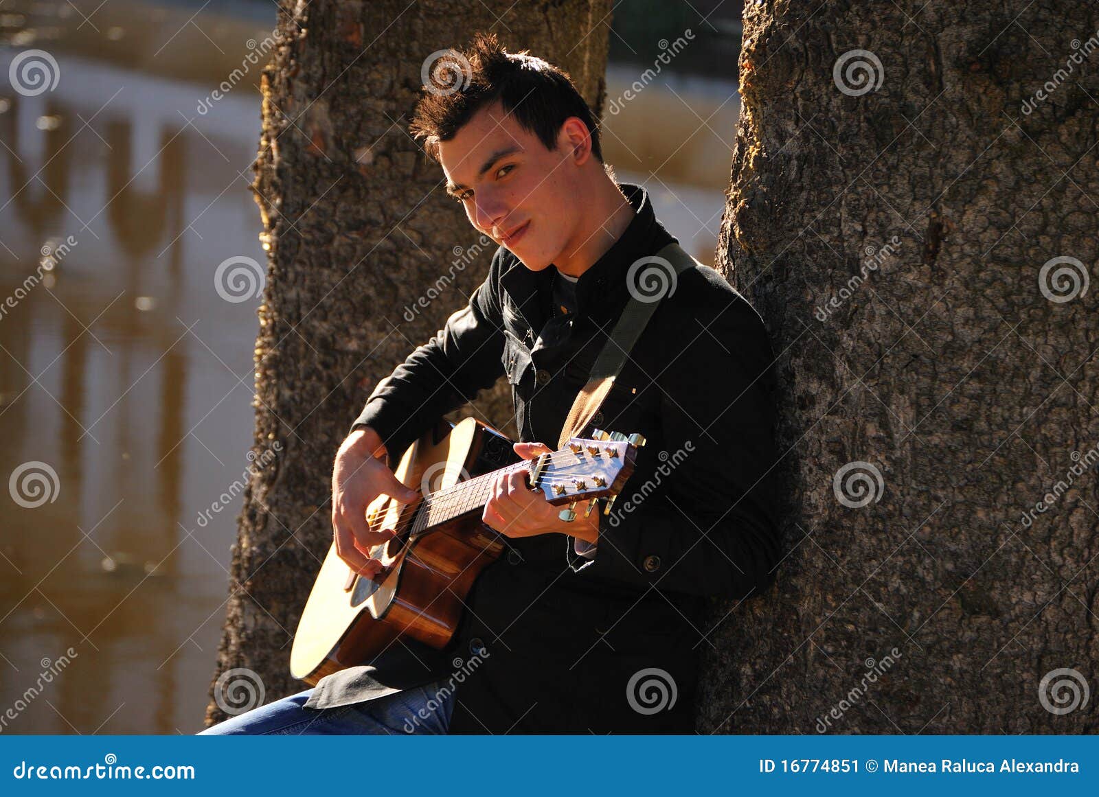 Man Playing Guitar Under Tree Stock Image - Image of play, nature: 16774851