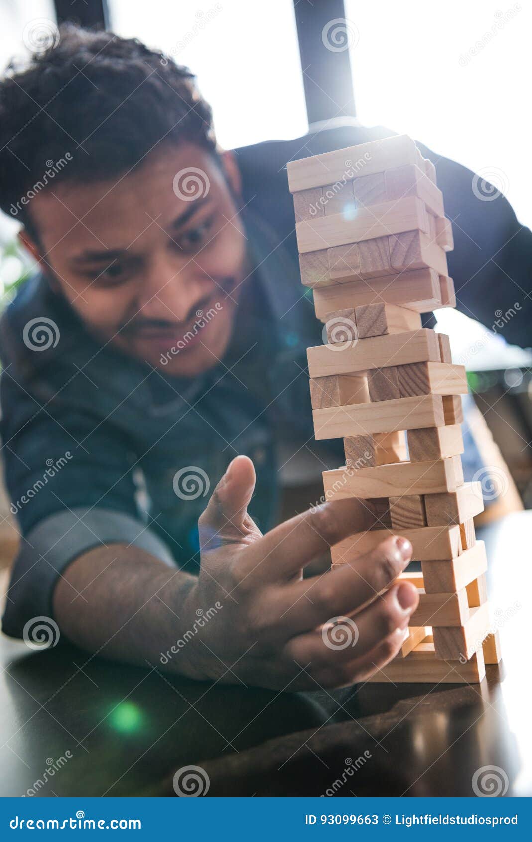 Man playing jenga game stock image. Image of jenga, aspiration - 93099663