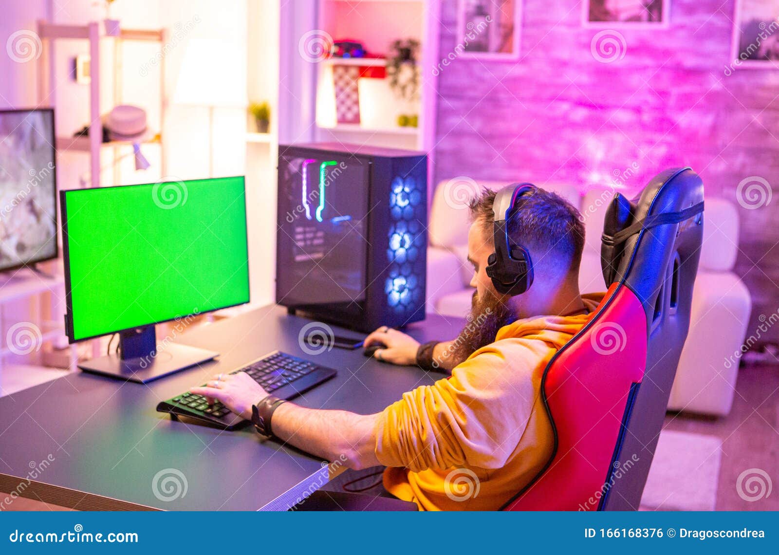 Man Playing on Powerfull Gaming Pc in a Room with Neon Lights on a ...