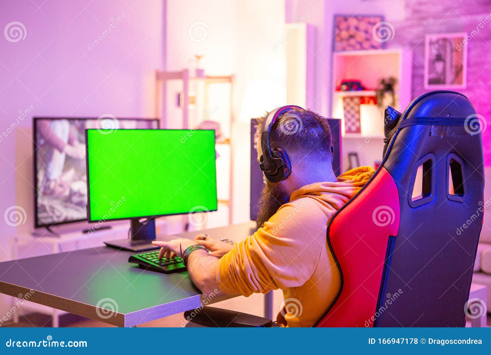 Man Playing on Powerfull Gaming Pc in a Room with Neon Lights on a ...
