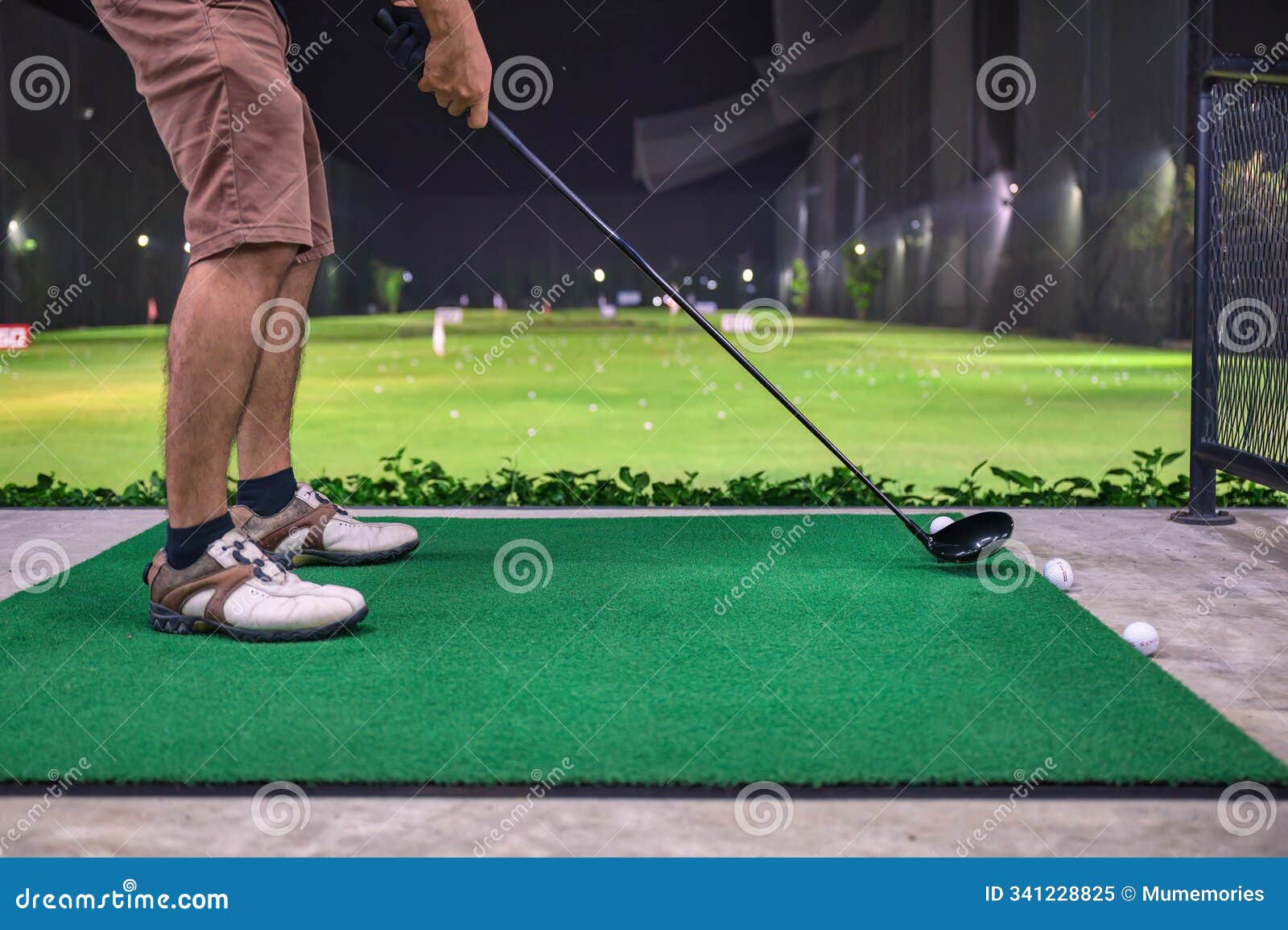 A Man Practicing with Golf Swing on Golf Course at Golf Driving Range ...