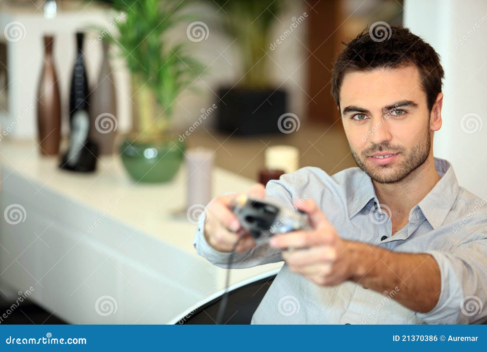 Man playing a video game stock photo. Image of absorbed - 21370386
