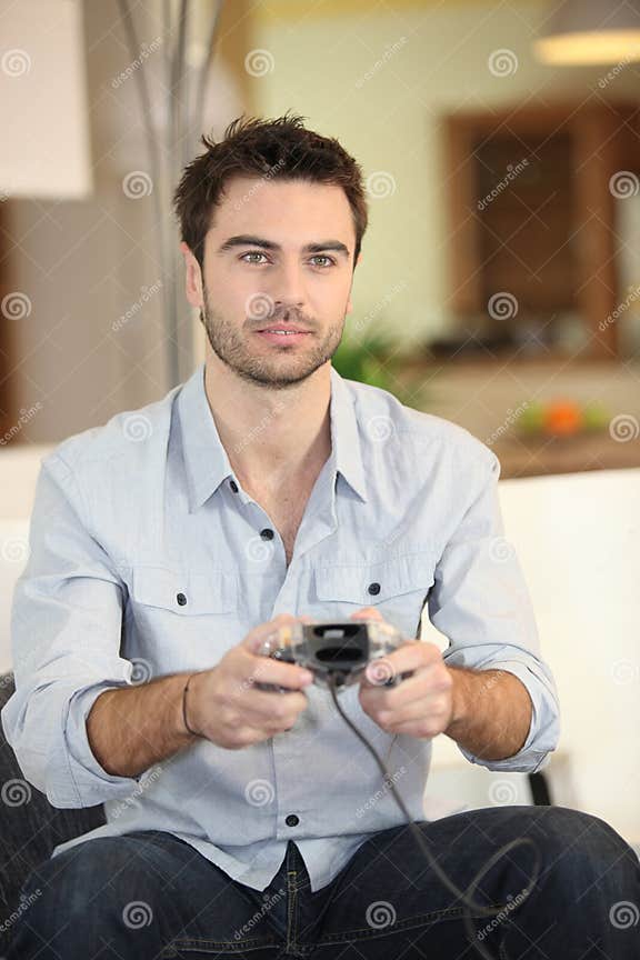 Man playing a video game stock photo. Image of enthralled - 22365758