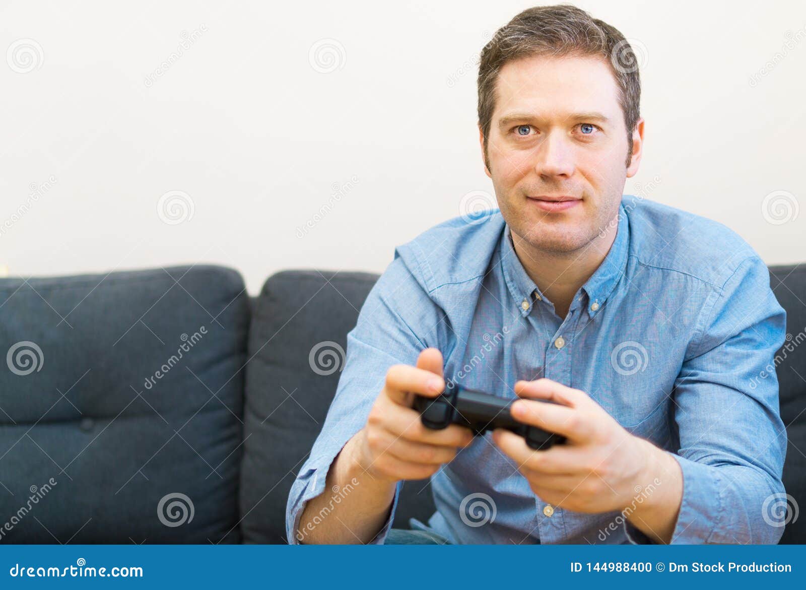 Man playing video game. stock photo. Image of gamer - 144988400