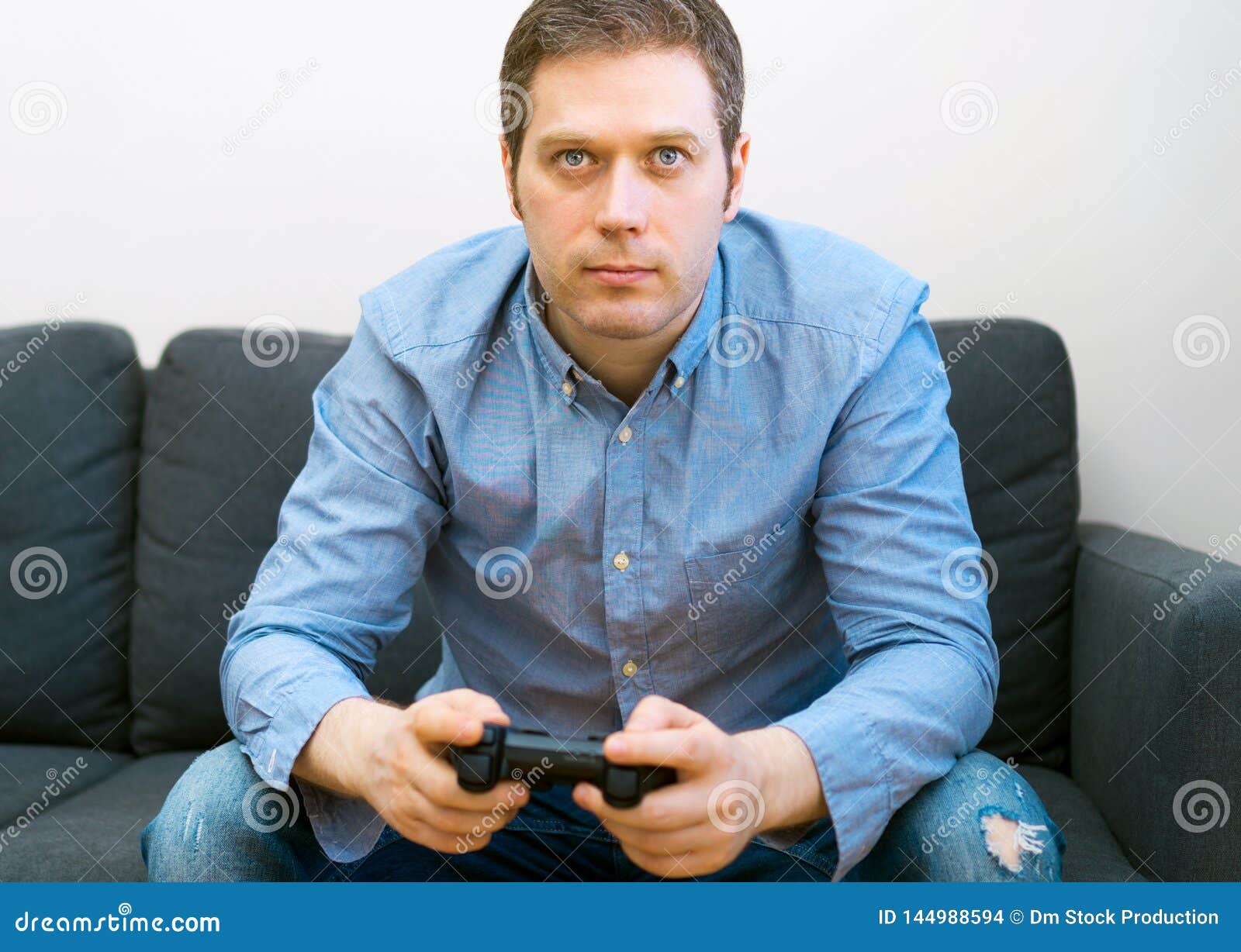 Man playing video game. stock photo. Image of equipment - 144988594