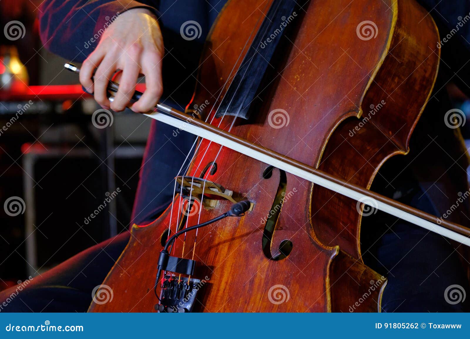 Man plays a cello on stage stock photo. Image of artist - 91805262