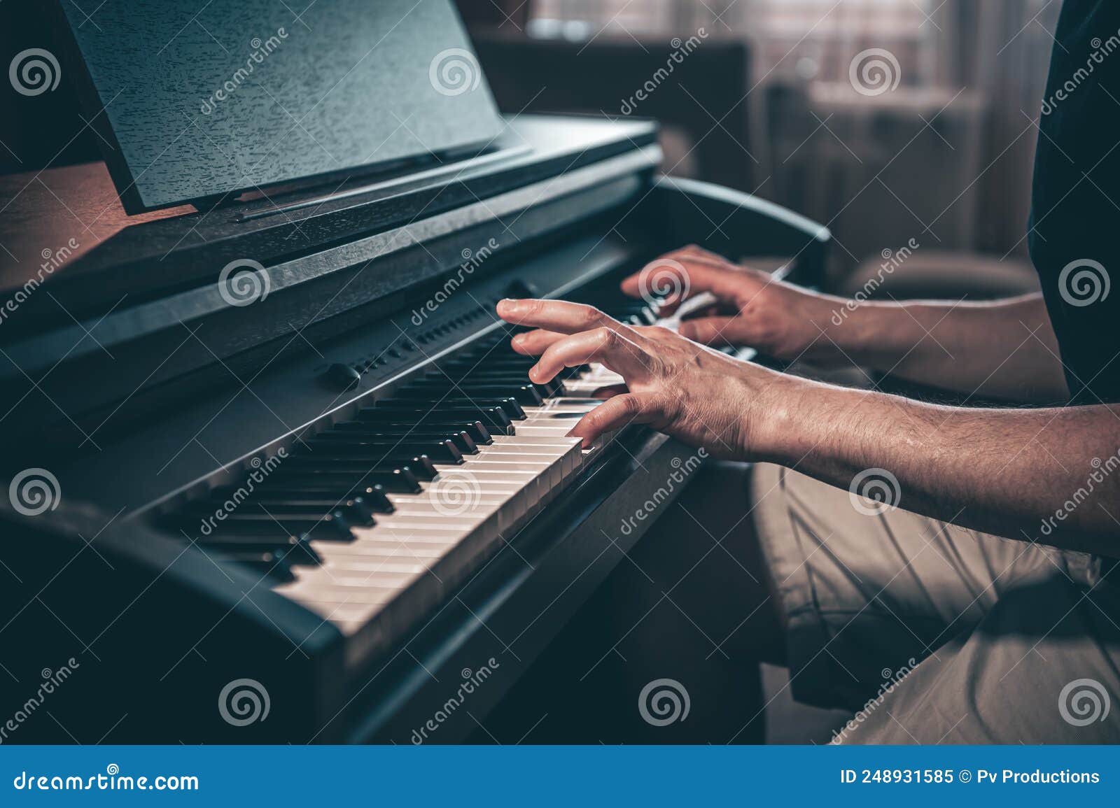 A Man Plays an Electronic Piano in a Dark Room. Stock Image - Image of ...