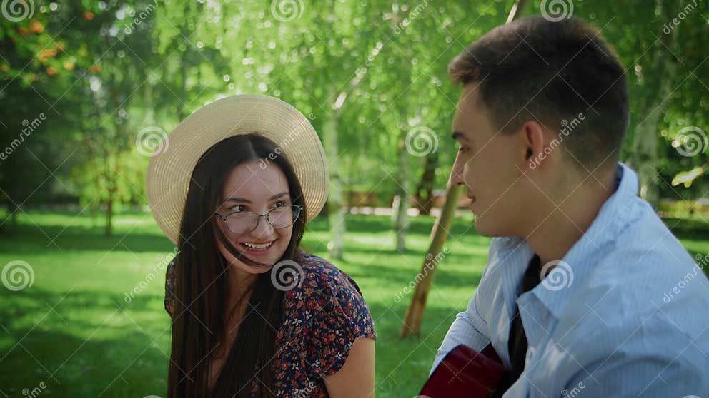 A Man Plays Guitar Next To His Girlfriend Stock Image Image Of Tenderness Style 255905013