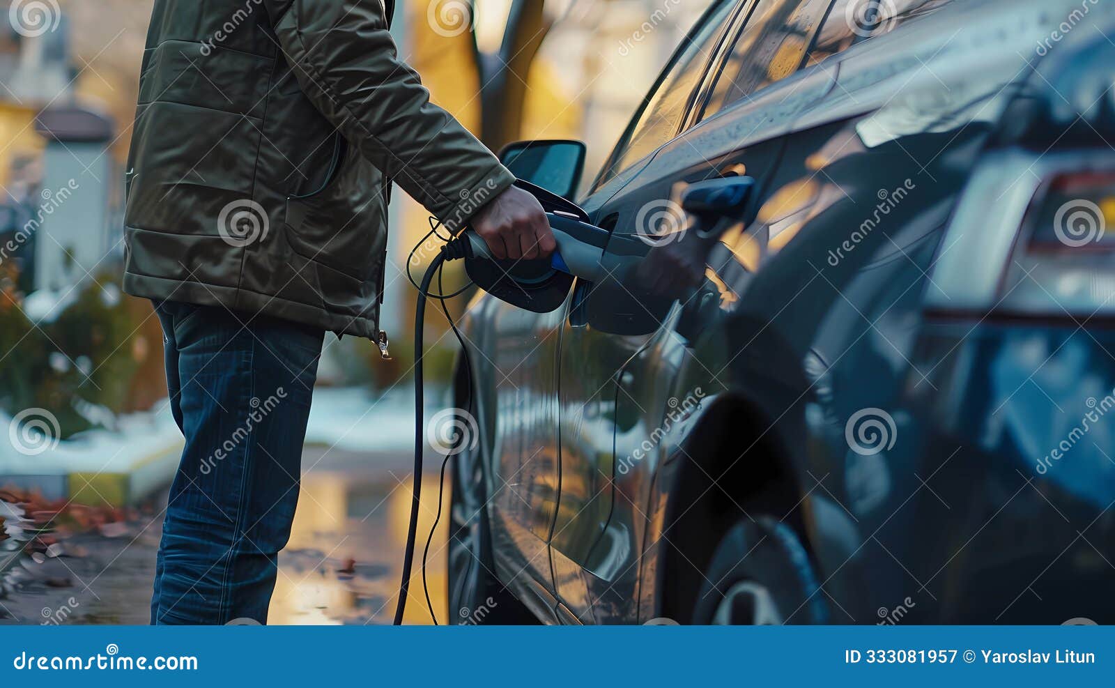 Man Plugging in Cable while Charging Electrical Car Close-up Stock ...