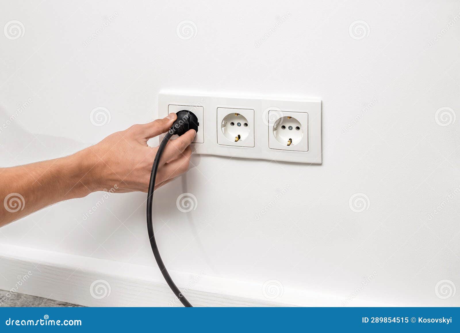 Man Plugging Cord into a Electrical Outlet Stock Image - Image of ...