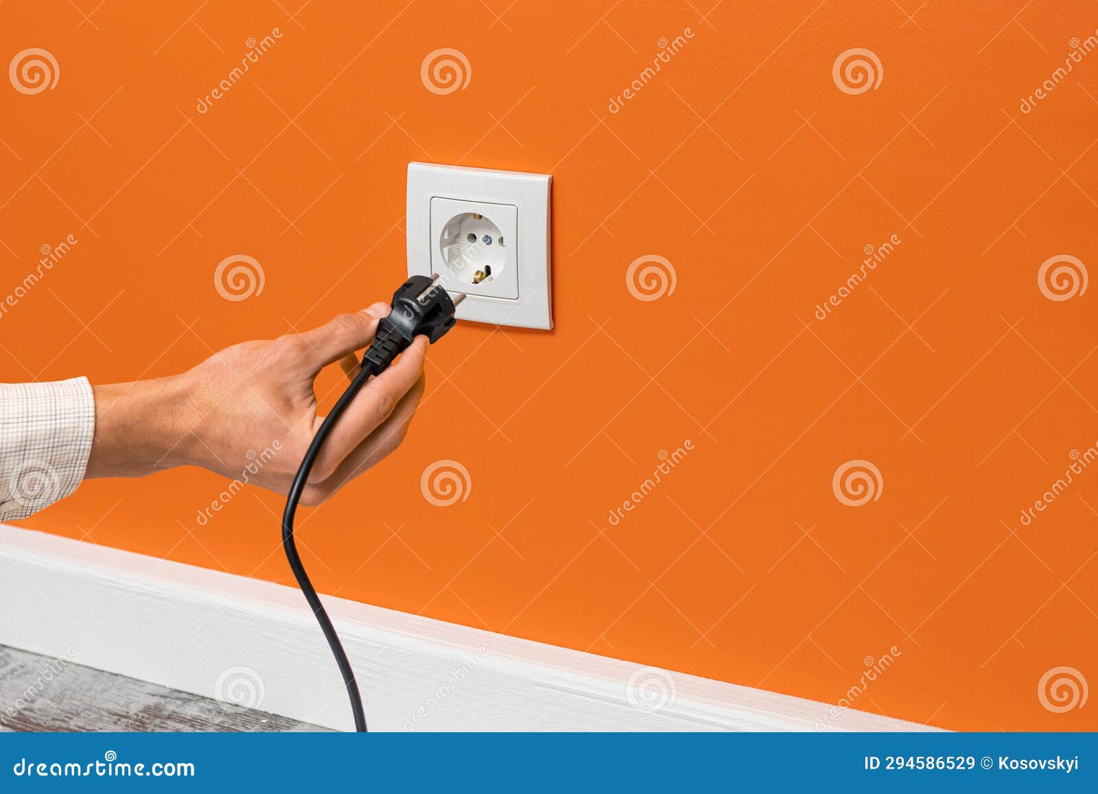 Man Plugging Cord into a Electrical Outlet Stock Image - Image of ...