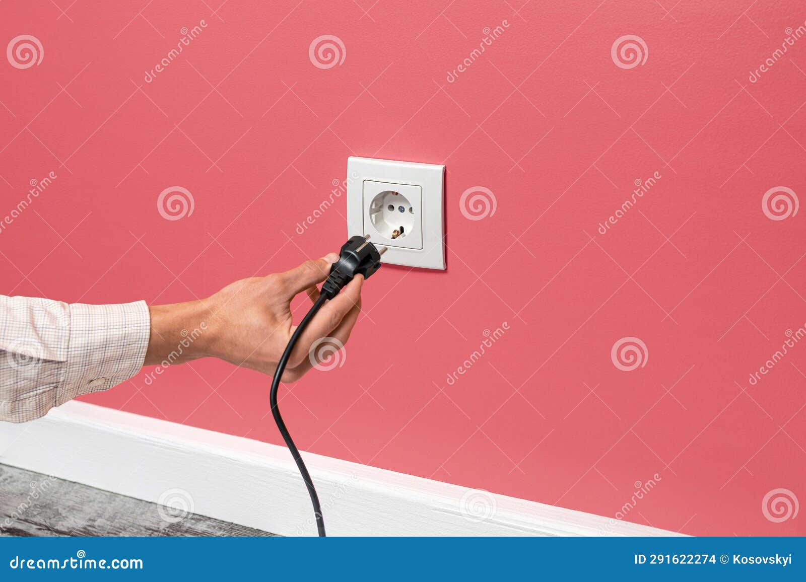 Man Plugging Cord into a Electrical Outlet Stock Photo - Image of ...