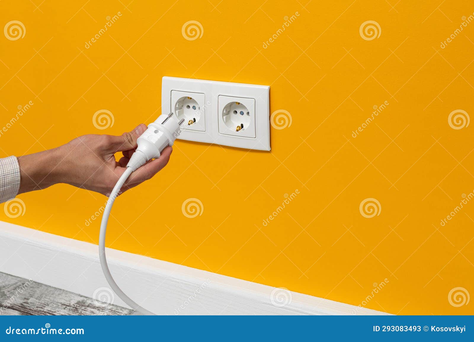 Man Plugging Cord into a Electrical Outlet Stock Image - Image of ...