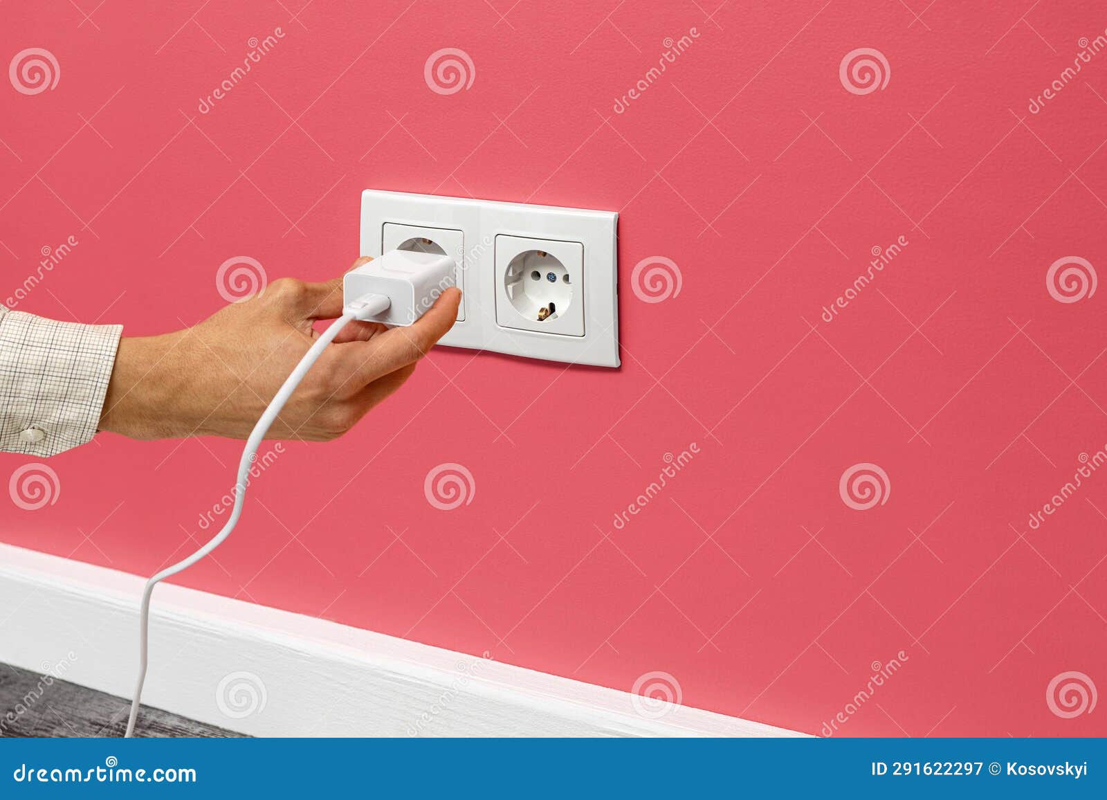 Man Plugging Phone Adapter into a Electrical Outlet Stock Image - Image ...