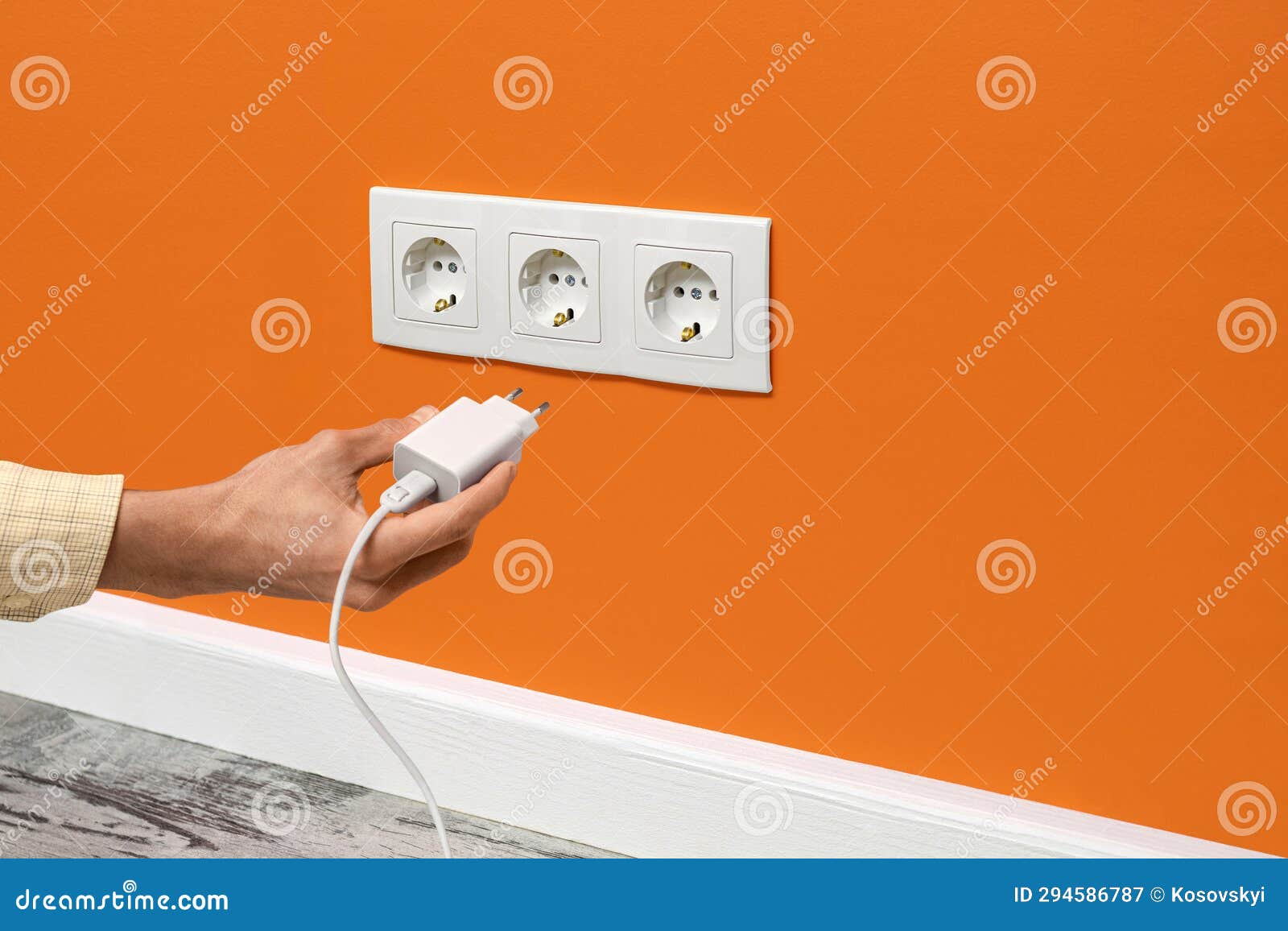 Man Plugging Phone Adapter into a Electrical Outlet Stock Image - Image ...