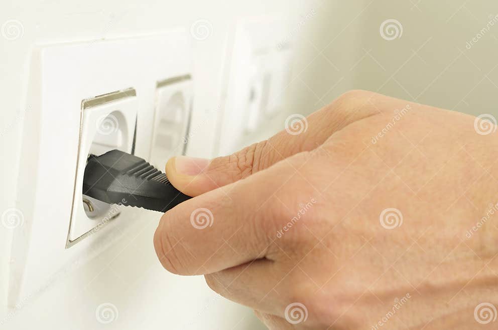 Man Plugging in or Unplugging an Electrical Plug in a Socket Stock ...