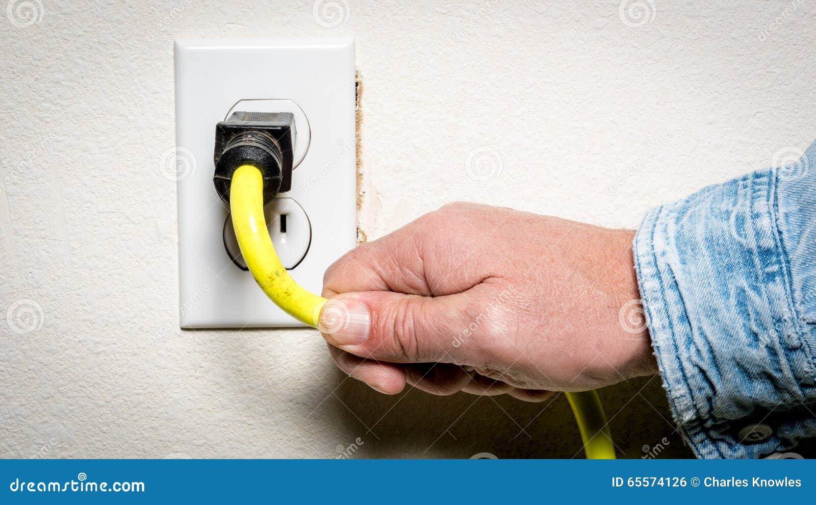 Man Plugs an Extention Cord into a Garage Outlet Stock Photo - Image of ...