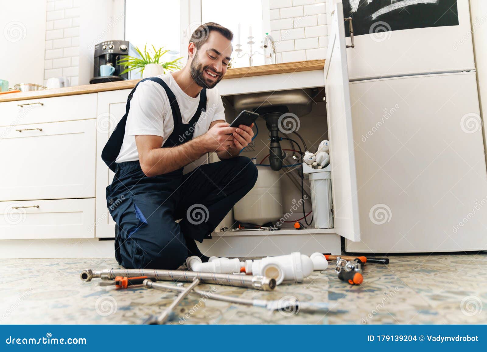 Man Plumber Work in Uniform Indoors Using Mobile Phone Stock Photo ...