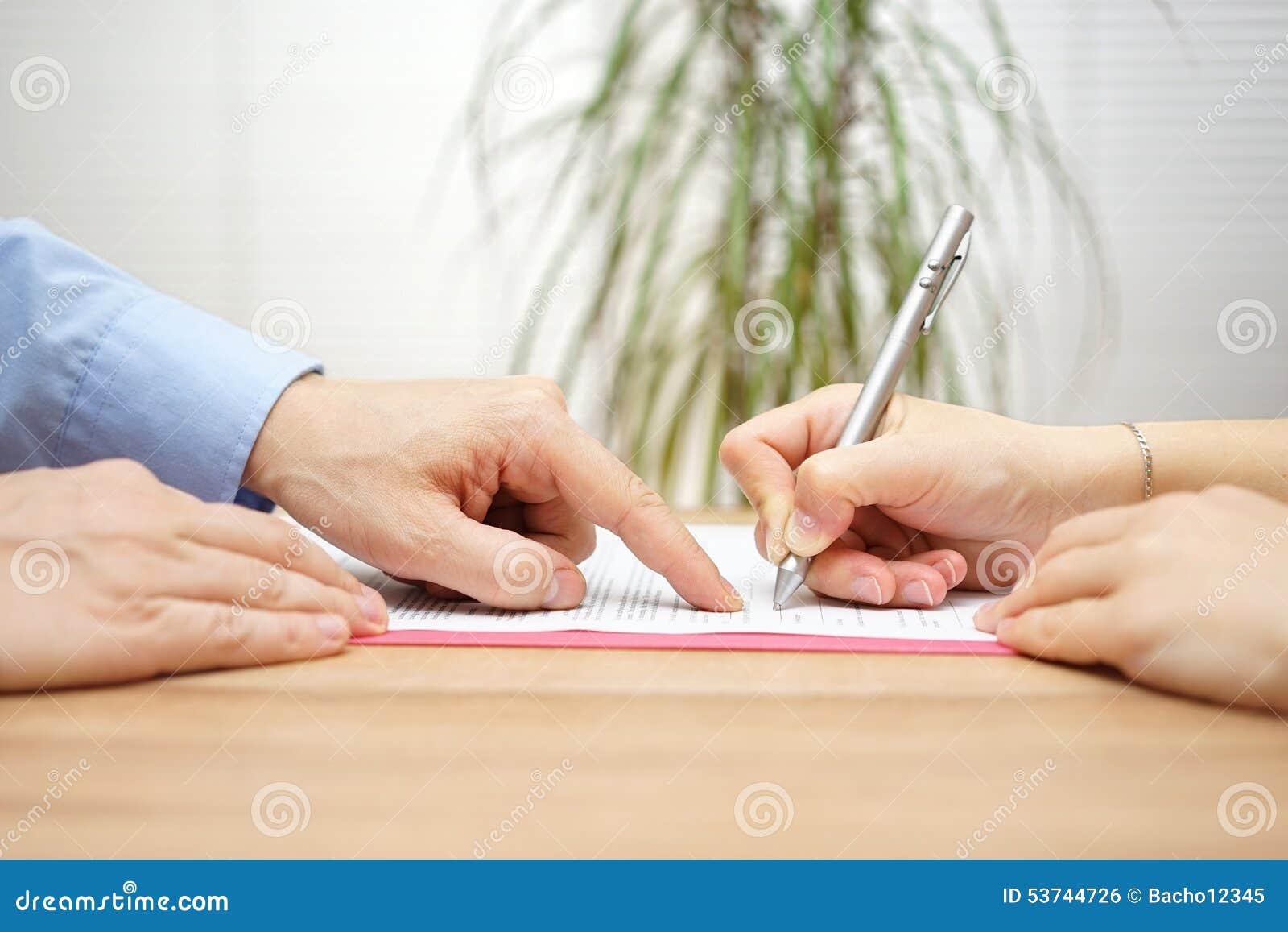 Man is Pointing a Place Where she Should Sign the Agreement Stock Photo ...