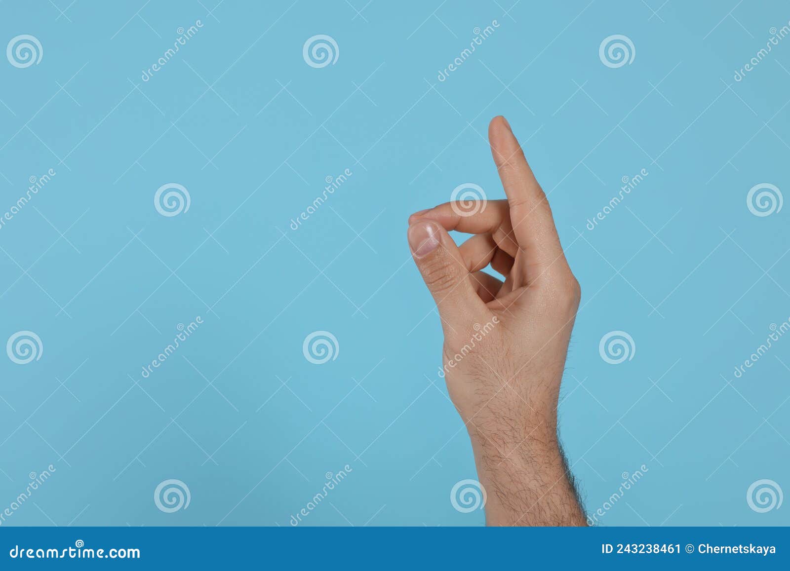 Man Pointing at Something on Light Blue Background, Closeup of Hand ...
