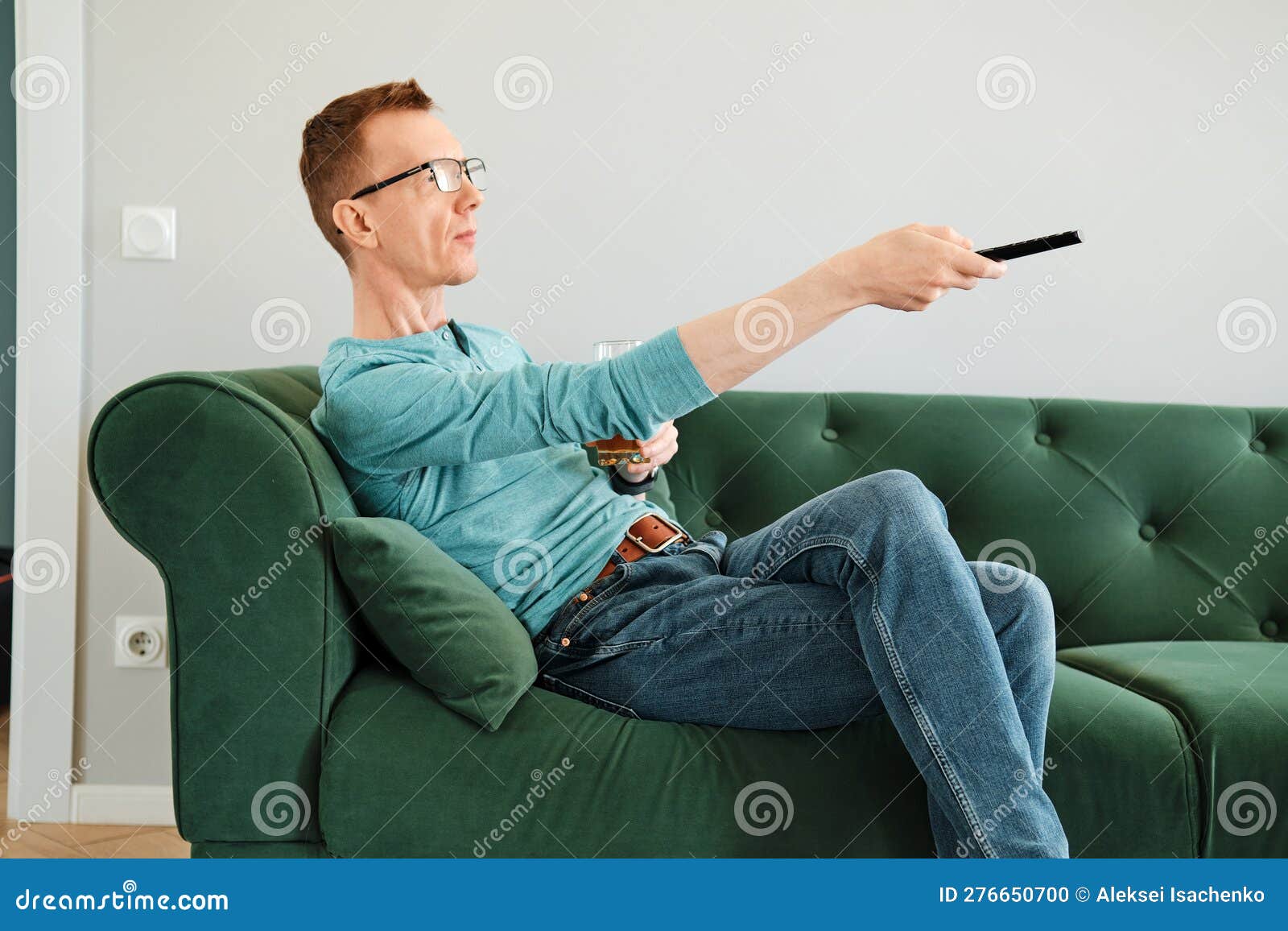 Man Pointing Tv Remote Control Sitting on Sofa in Living Room Stock ...