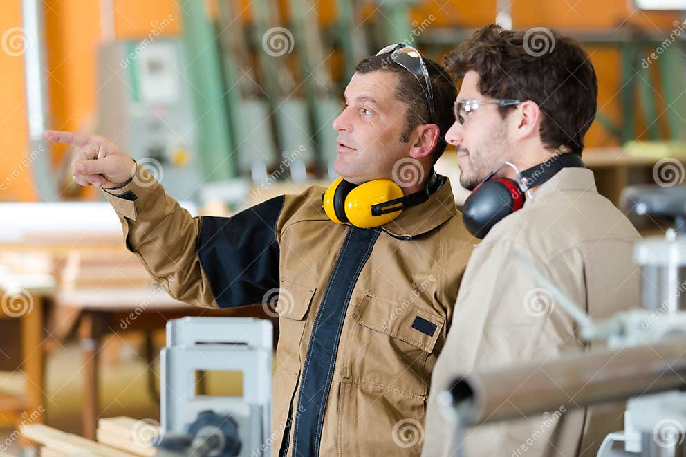 Man Pointing at Upper Shelf while Talking To Worker Stock Photo - Image ...