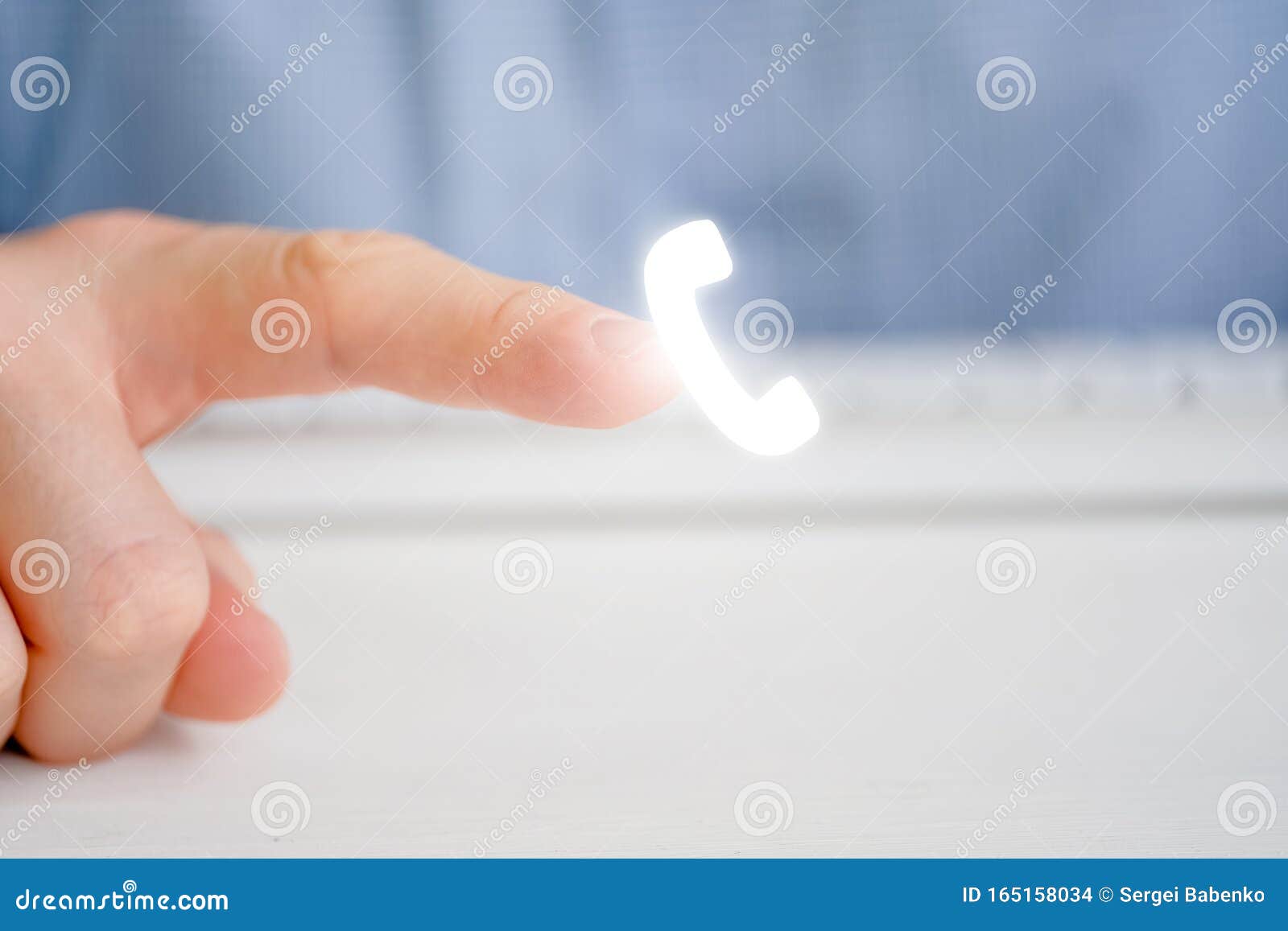 A Man Points His Finger at the Phone Icon. Call Concept To Make a Call ...