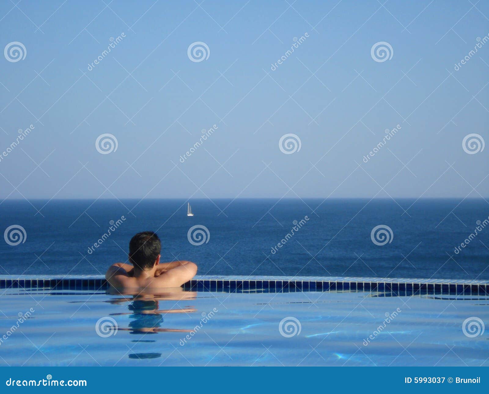 Man in Infinity Pool Staring at Sea Stock Image - Image of swimming ...
