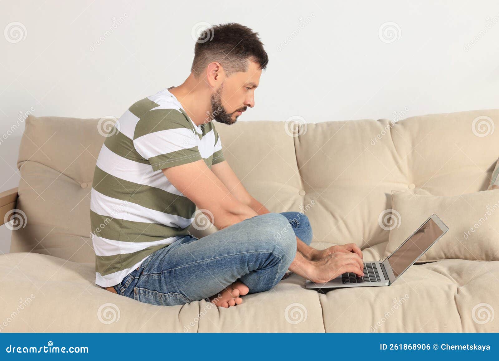 Man with Poor Posture Using Laptop on Sofa at Home Stock Photo - Image ...