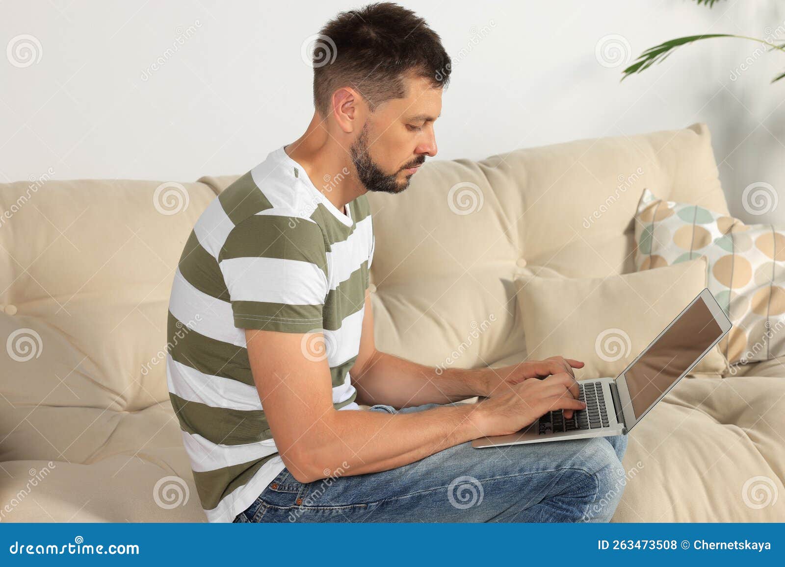 Man with Poor Posture Using Laptop on Sofa at Home Stock Photo - Image ...