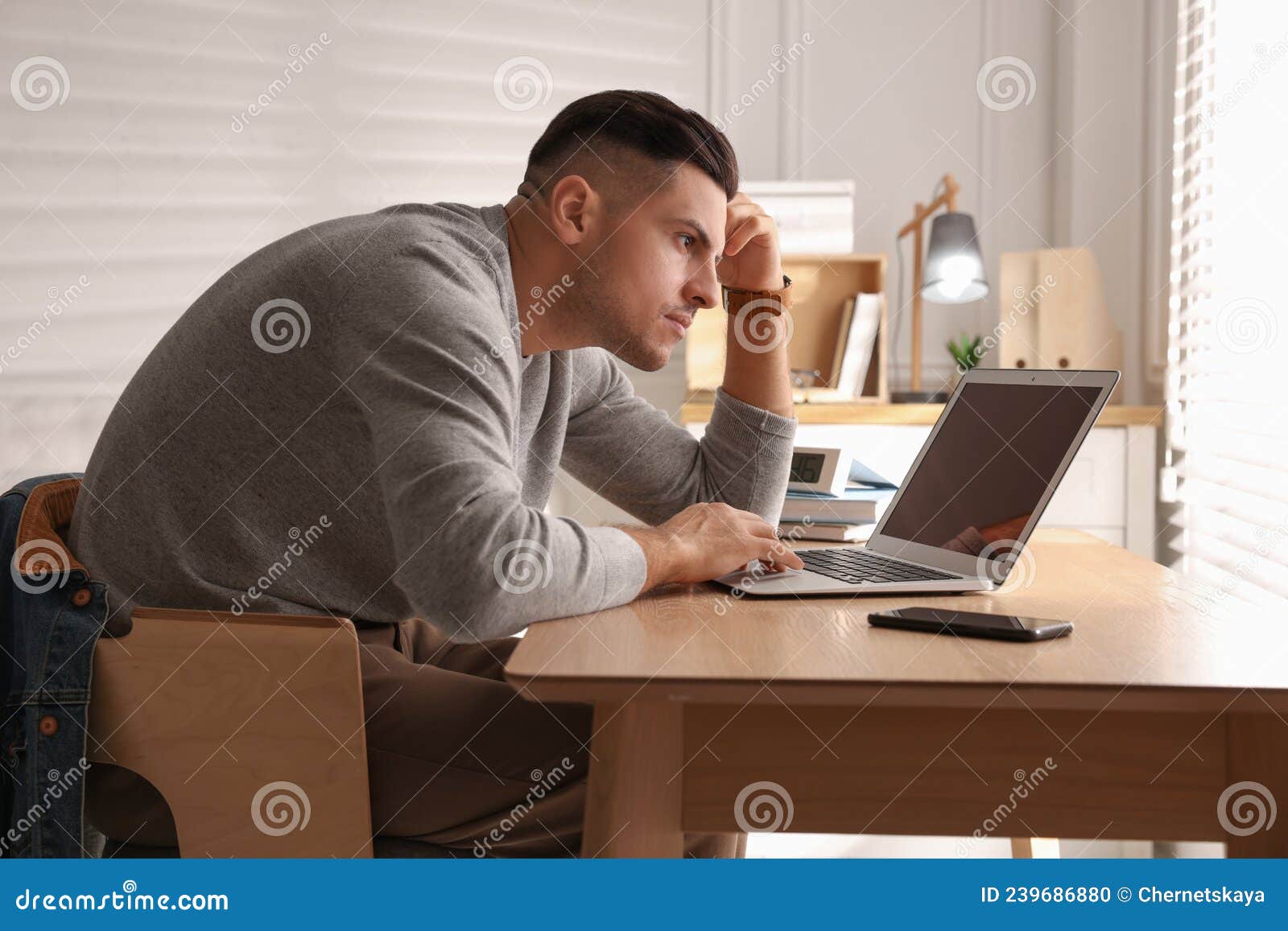 Man with Poor Posture Using Laptop at Table Indoors Stock Photo - Image ...