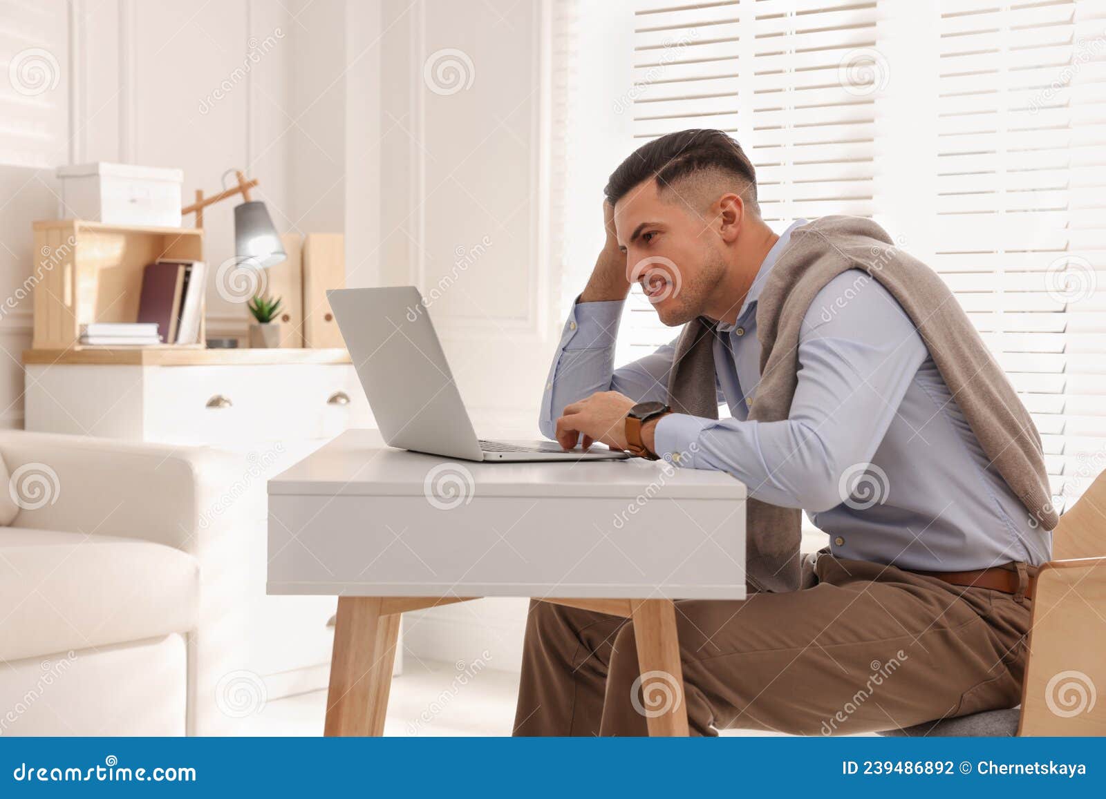Man with Poor Posture Using Laptop at Table Indoors Stock Photo - Image ...