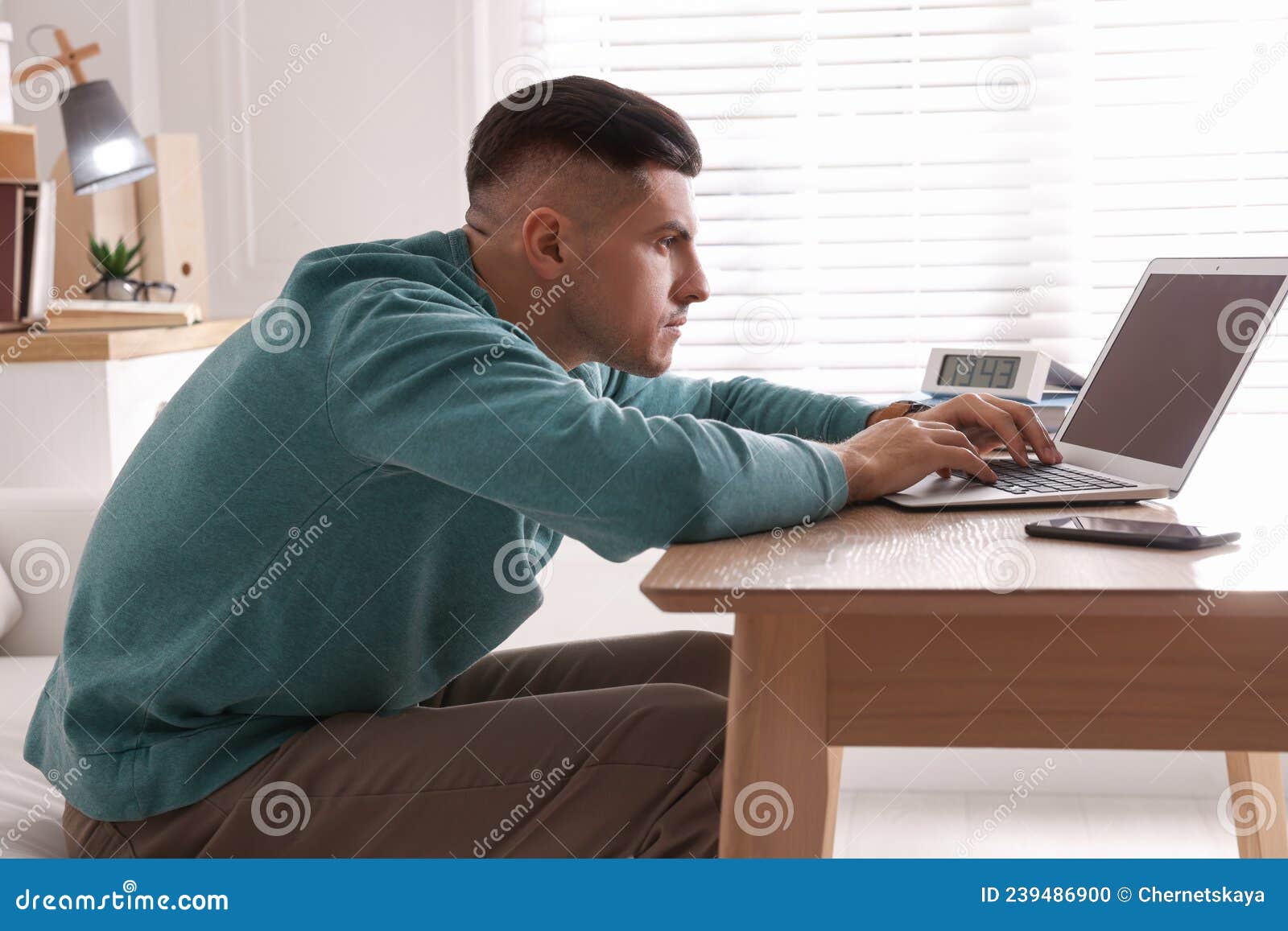 Man with Poor Posture Using Laptop at Table Indoors Stock Photo - Image ...